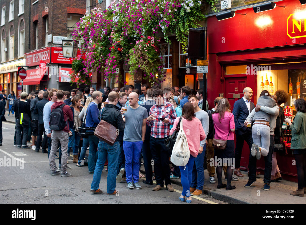 Crowd standing outside a pub in Soho, London, England, UK Stock Photo - Alamy