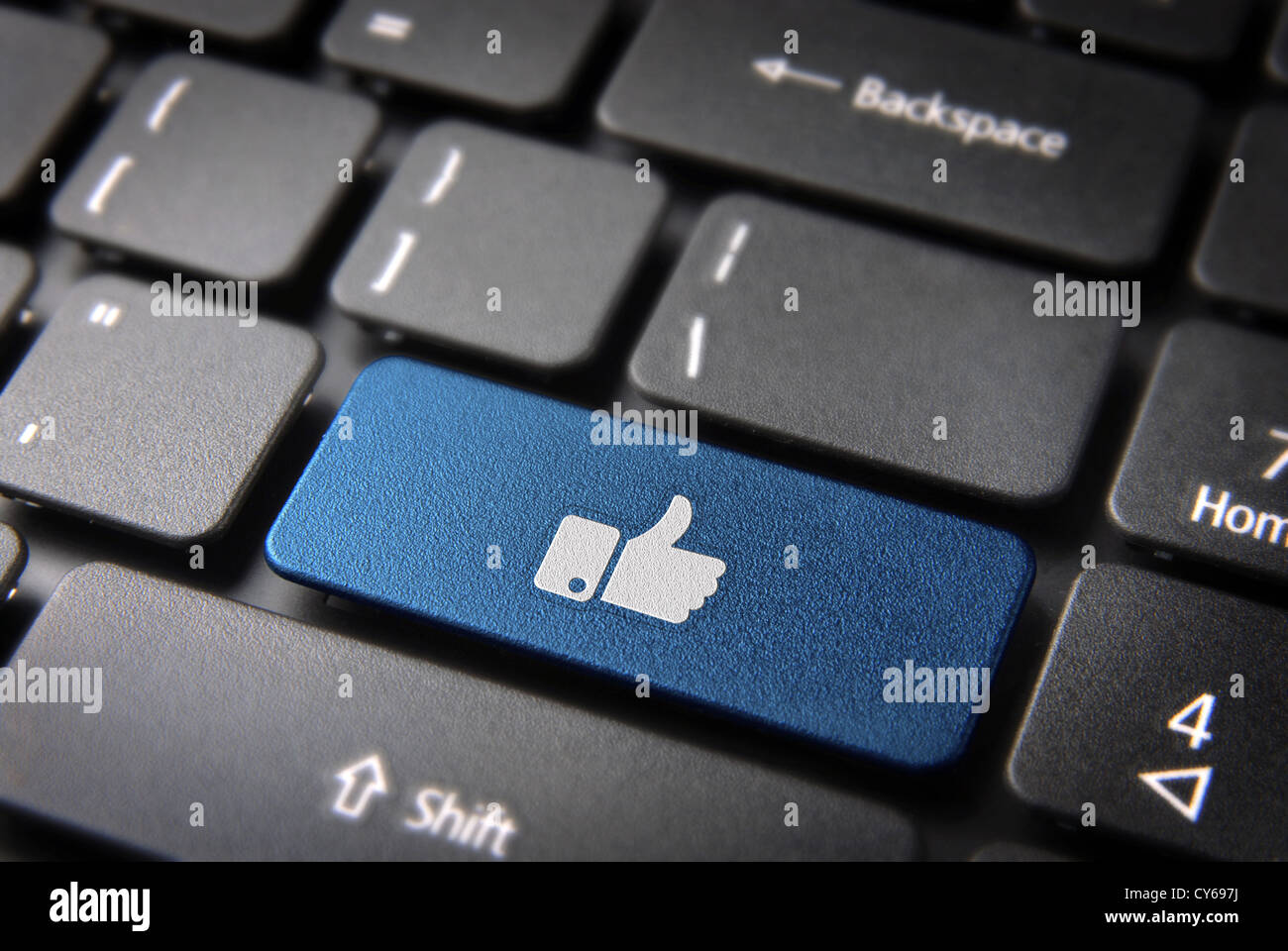Social media blue key with thumb up icon on laptop keyboard. Included ...