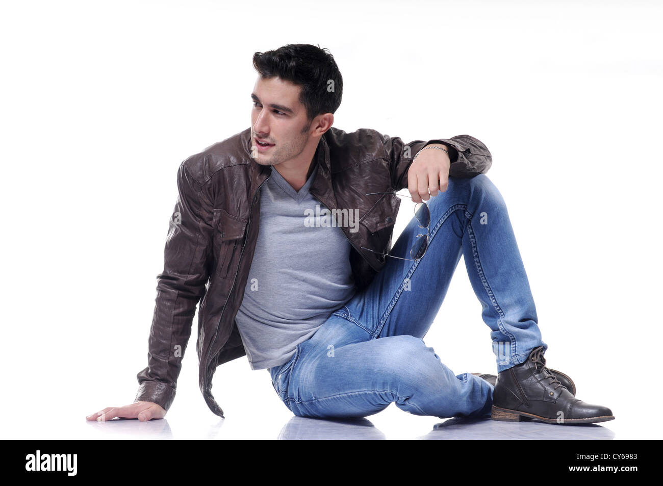 Fashion male sitting Stock Photo - Alamy