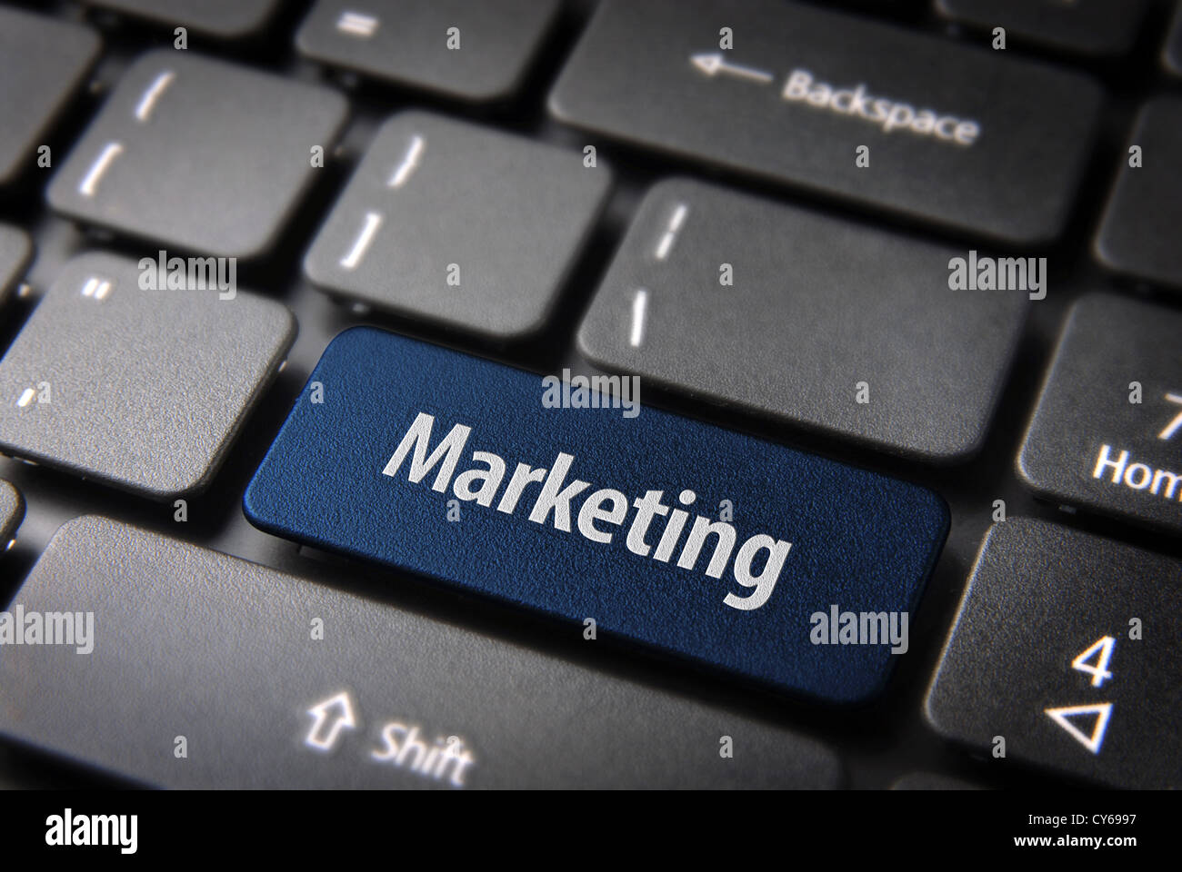 Blue key with marketing text on laptop keyboard. Included clipping path ...