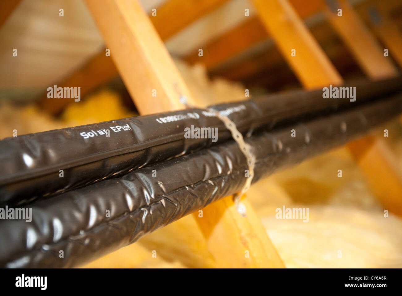 Pipes being run through a loft space to connect to a solar thermal ...
