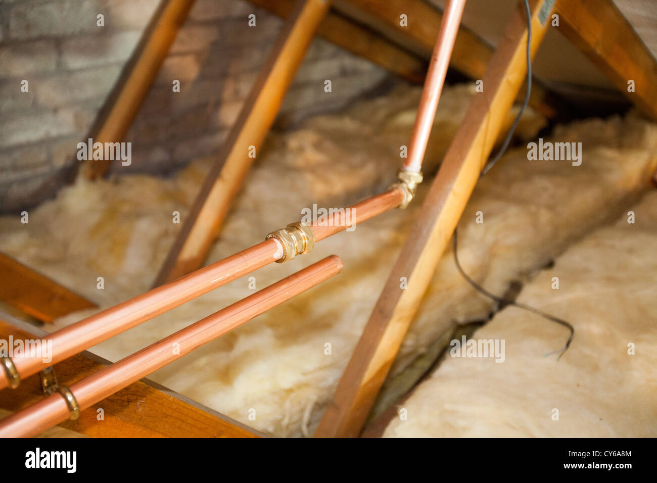 Pipes being run through a loft space to connect to a solar thermal ...