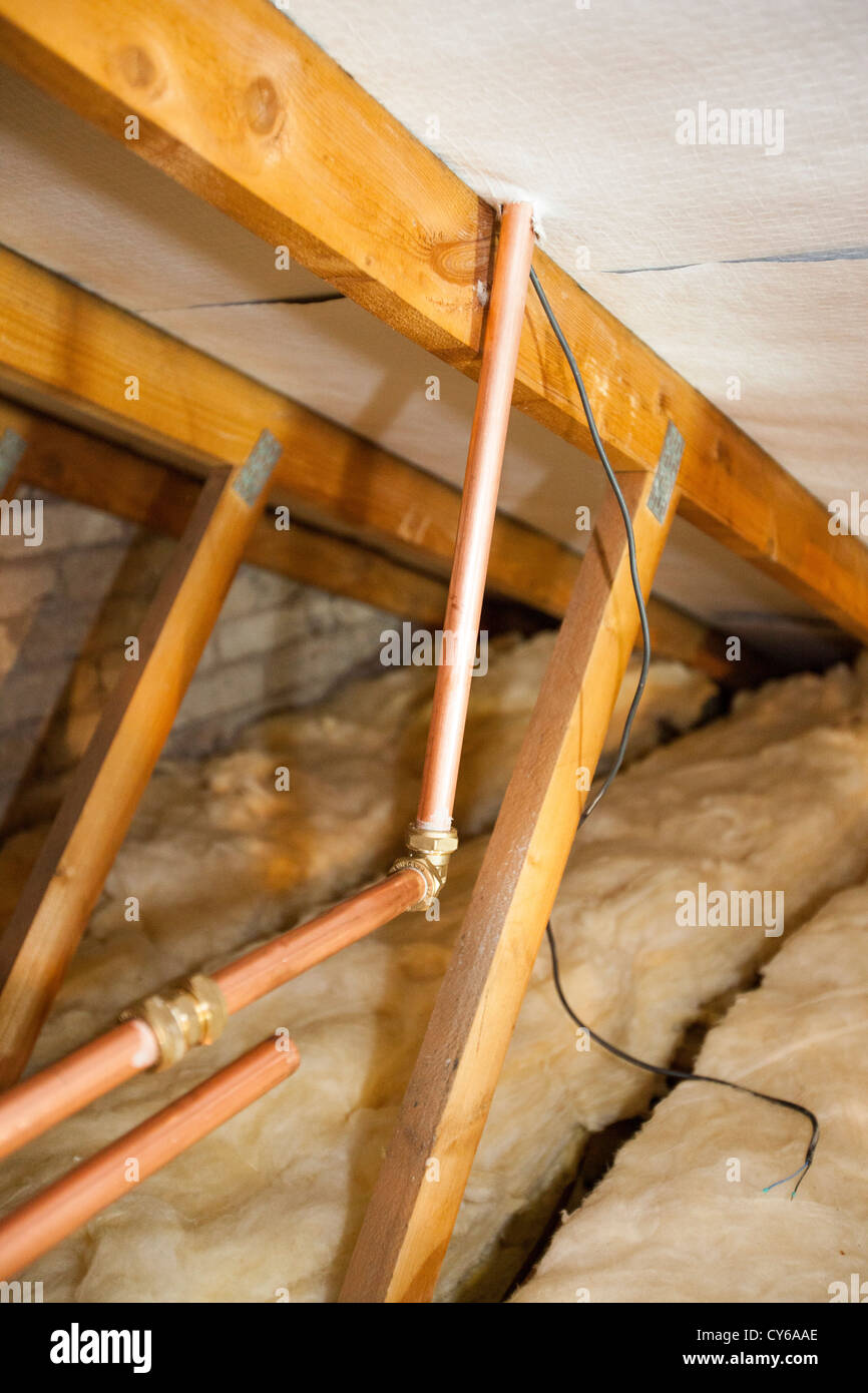 Pipes being run through a loft space to connect to a solar thermal ...