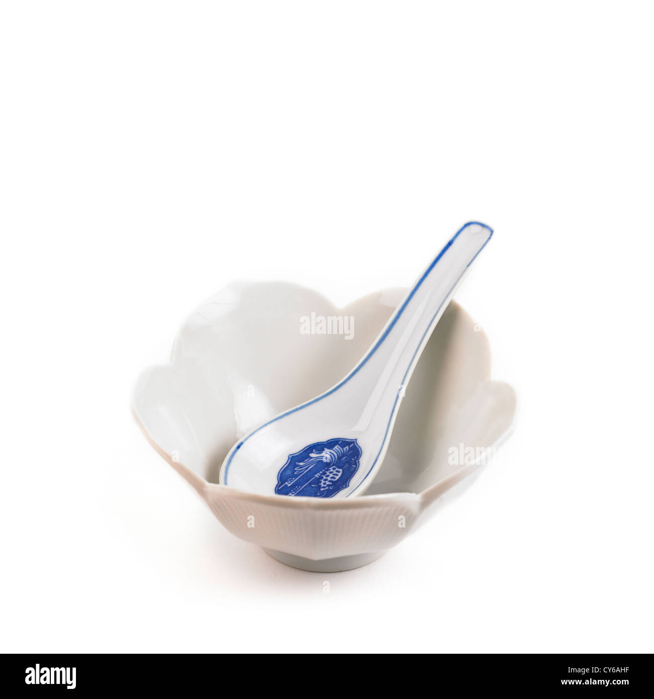 Chinese spoon in white food bowl on white background Stock Photo - Alamy