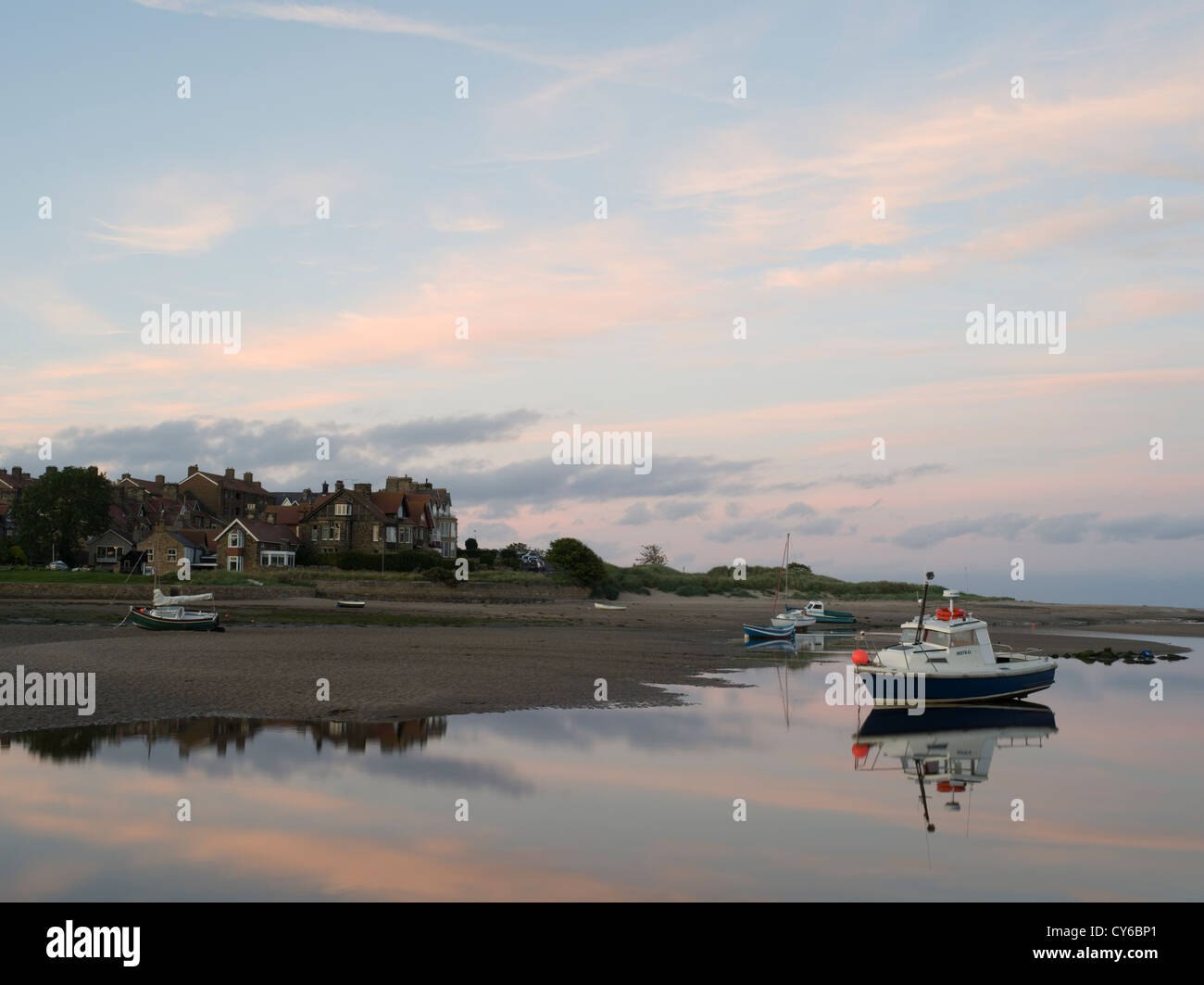 Looking across the Aln Estuary to Alnmouth village at sunset on the ...