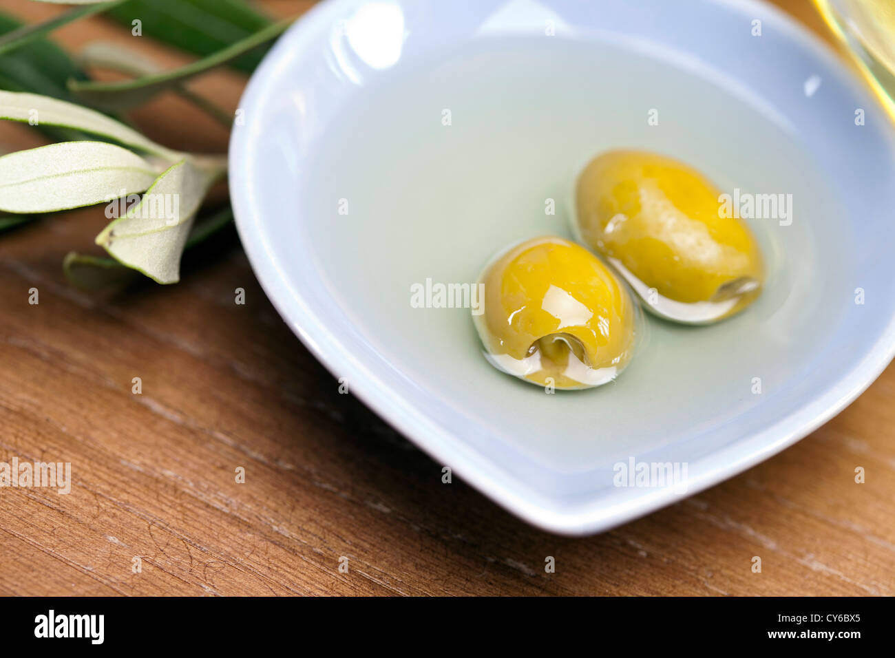Fresh olives, olive oil on olive wood. Extra virgin Stock Photo - Alamy