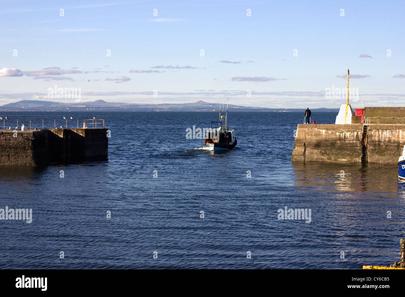 Fishing boat leaving Port Seton harbour Stock Photo - Alamy