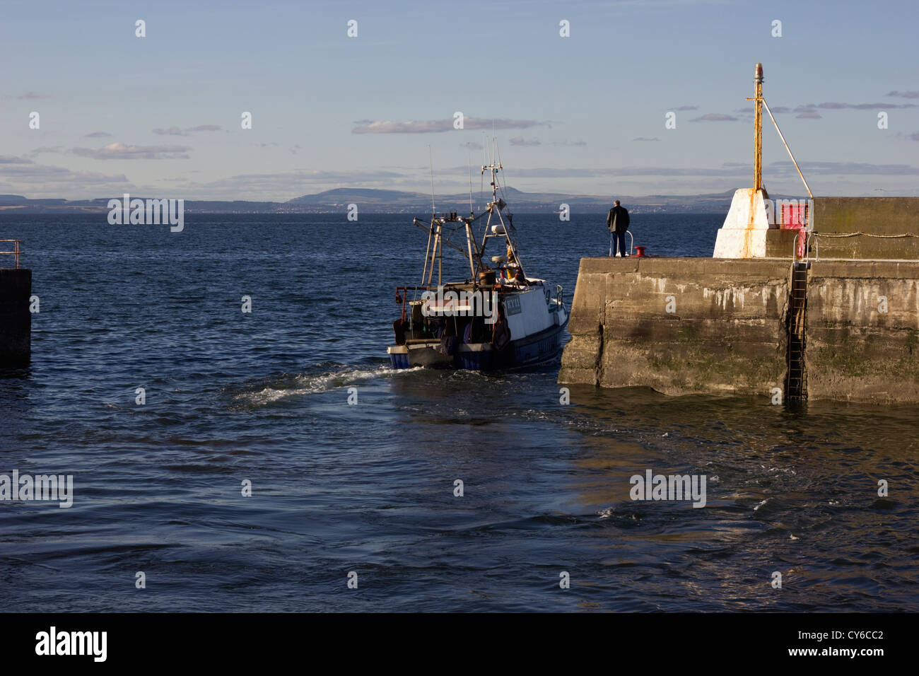 Fishing boat leaving Port Seton harbour Stock Photo - Alamy