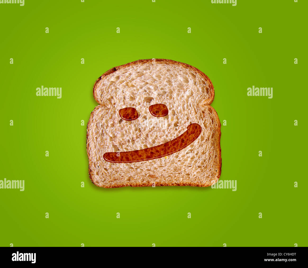 toasted bread slice with smile sign on green made by honey background ...