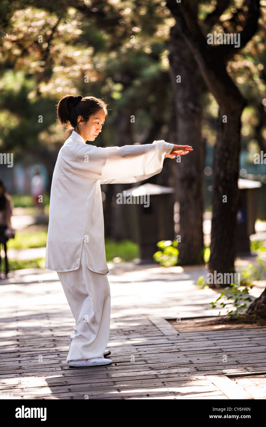 Chinese woman practices tai chi martial arts exercise early morning at ...
