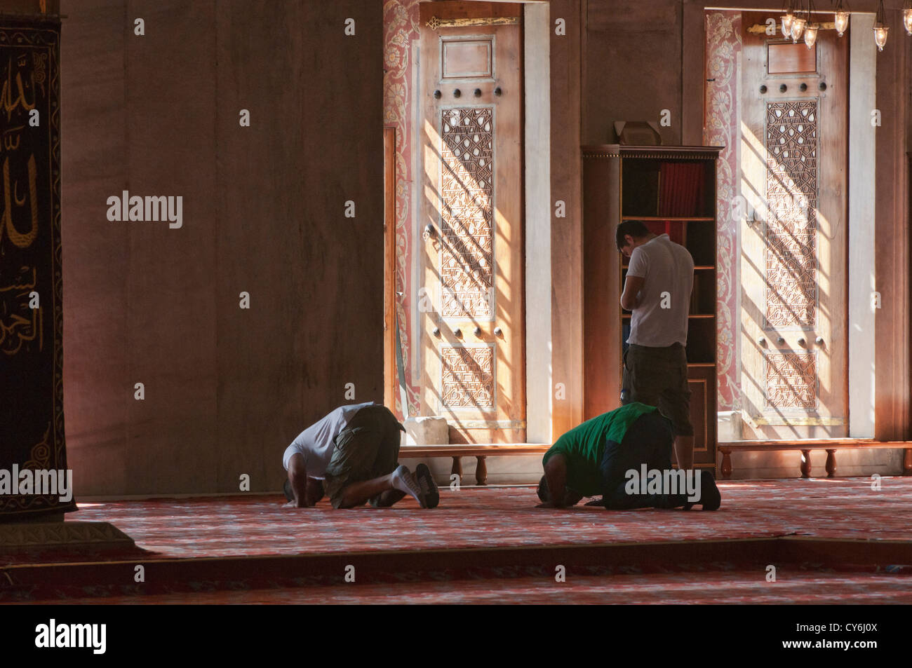 praying inside the Blue Mosque (Sultanahmet Mosque), symbol of Istanbul ...