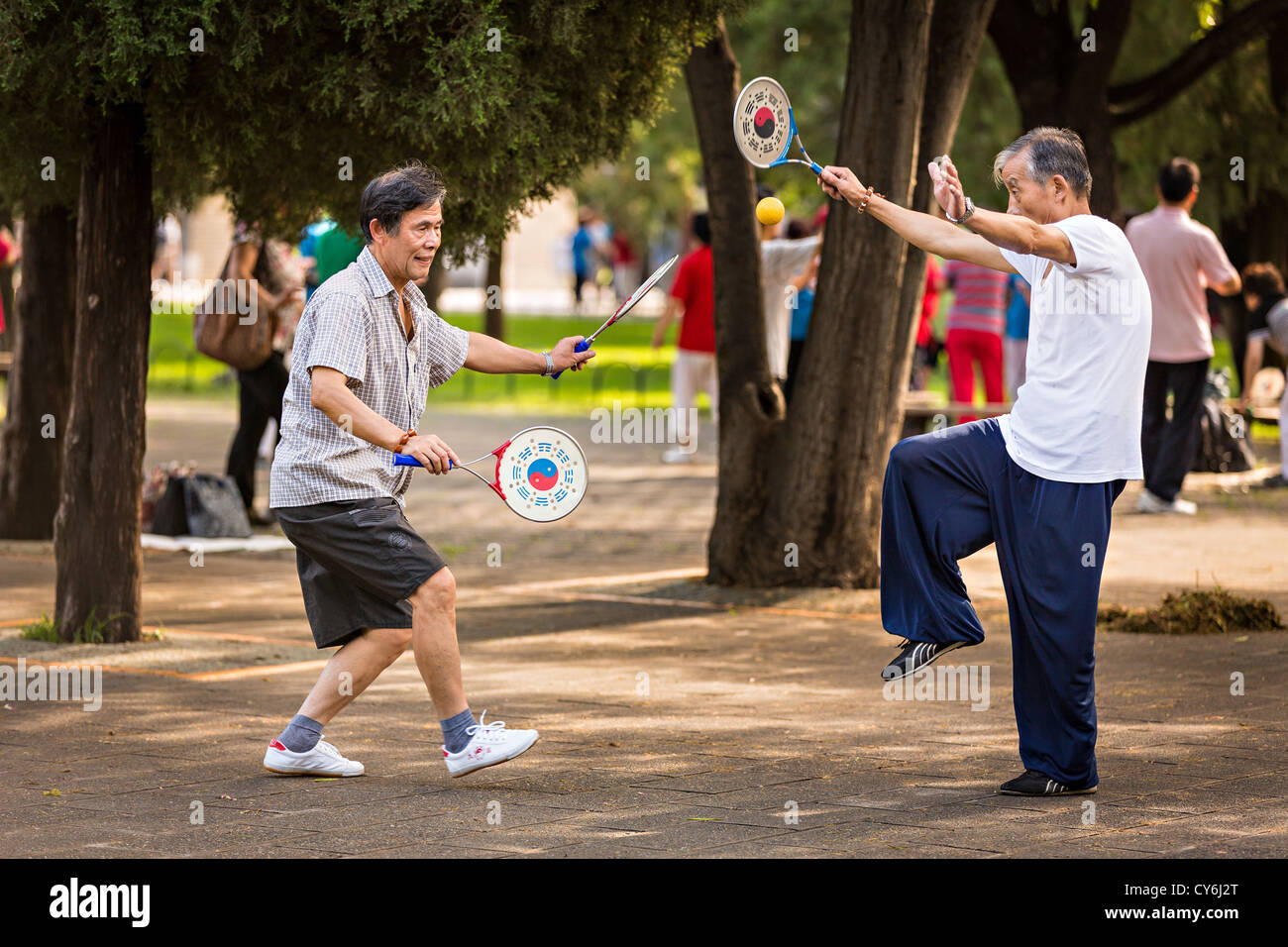 Elderly chinese men play bailong paddle ball exercise early morning at ...