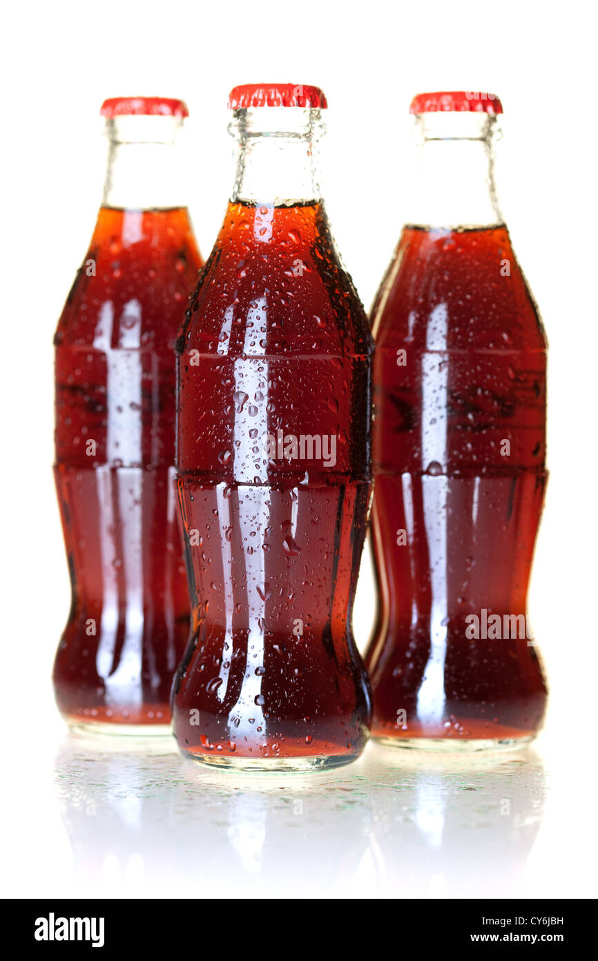 Three bottles of cold cola with water drops. Isolated on white Stock ...