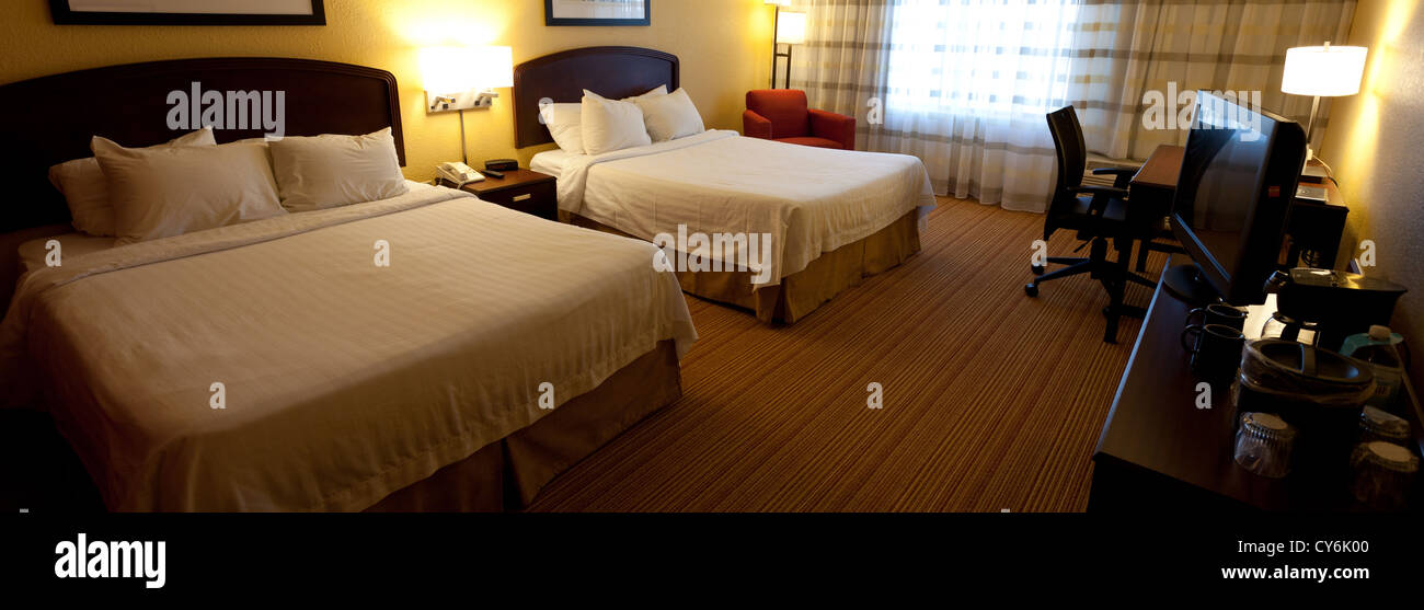 A nice hotel room interior with two beds a television etc Stock Photo ...