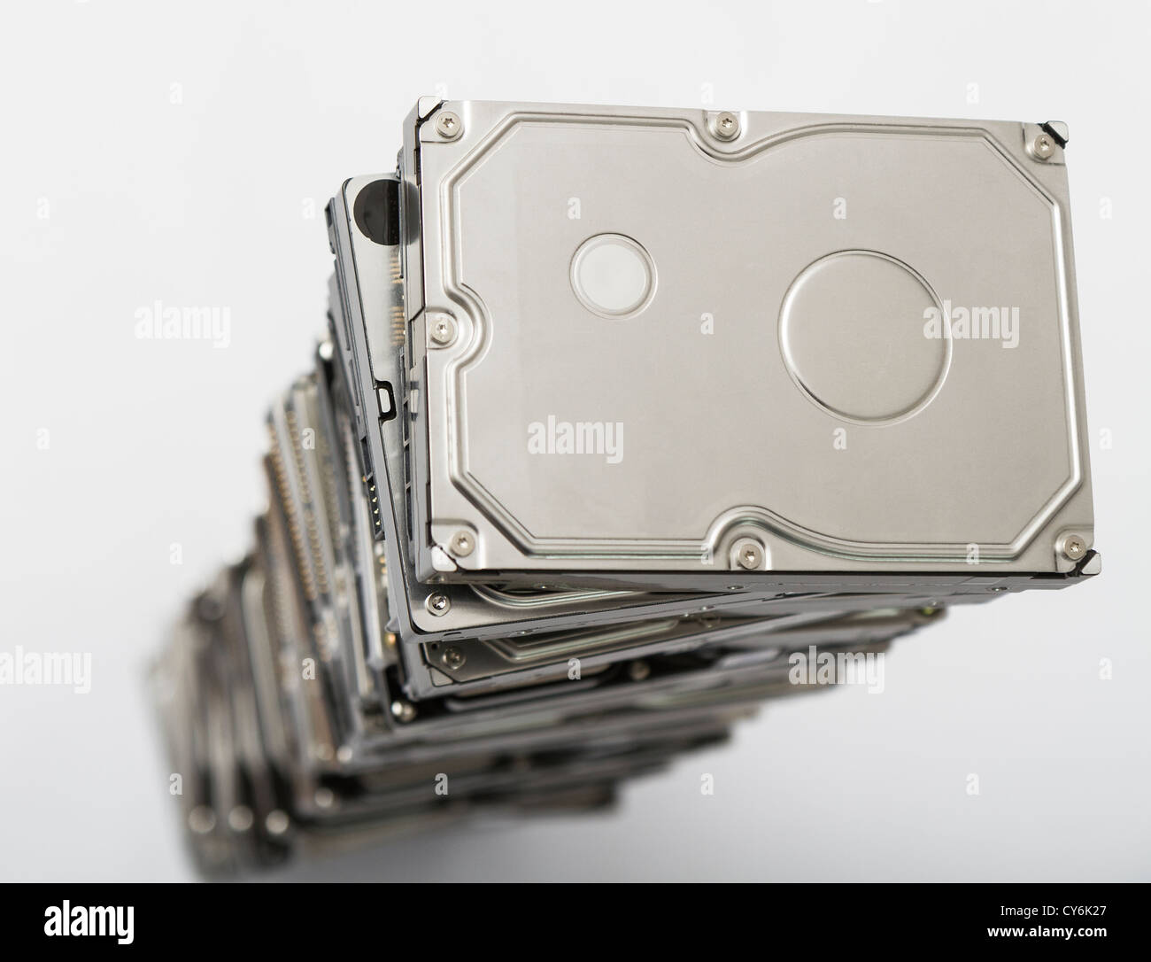 high stack of used hard drives in light background Stock Photo - Alamy
