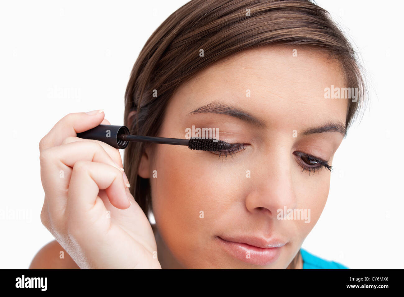 Relaxed teenager carefully applying her mascara on her eye Stock Photo ...