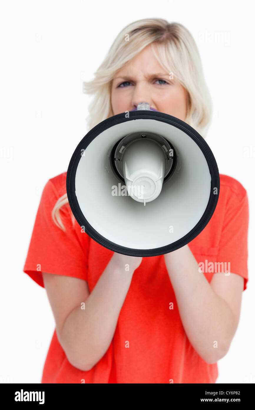 Woman looking upset while speaking into a megaphone Stock Photo - Alamy