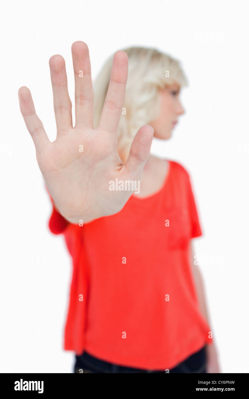 Stop sign made by a young blonde woman Stock Photo - Alamy