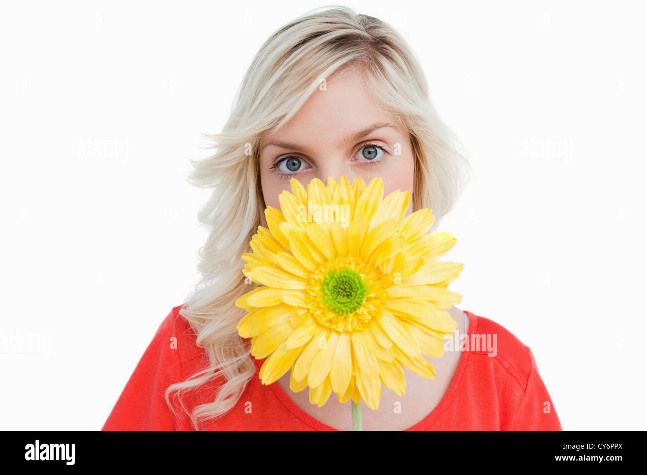 Fair-haired woman hiding her face behind a yellow flower Stock Photo ...