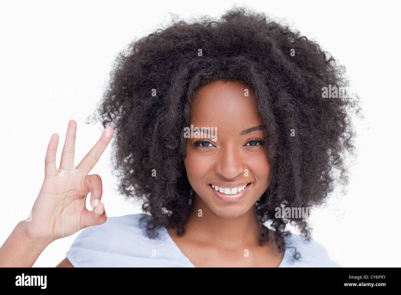Young woman making the OK sign while smiling Stock Photo - Alamy