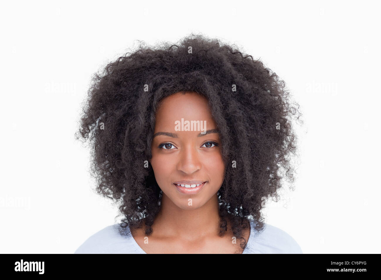 Young woman with curly hairstyle standing upright Stock Photo - Alamy