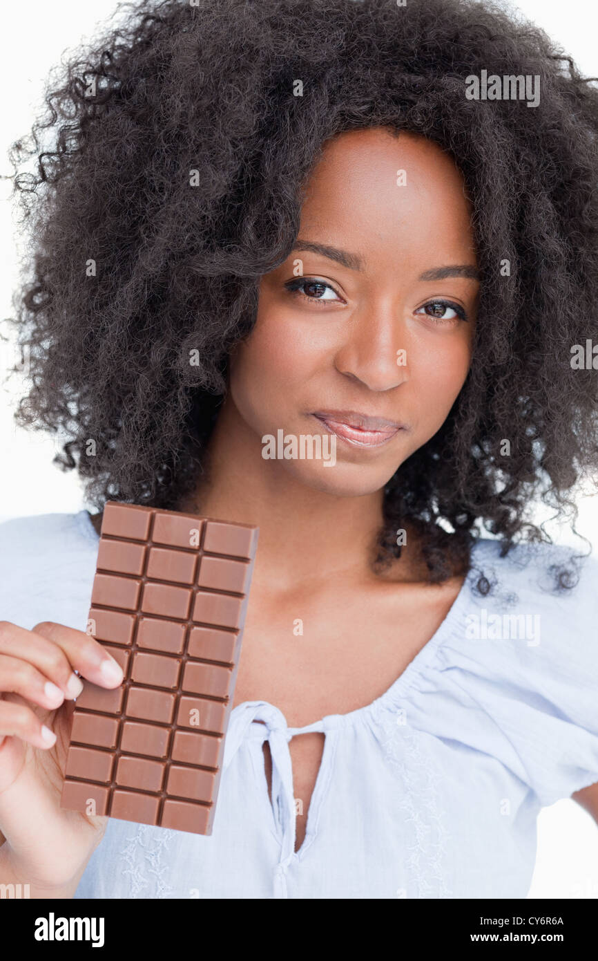 Young woman holding a delicious chocolate bar Stock Photo - Alamy