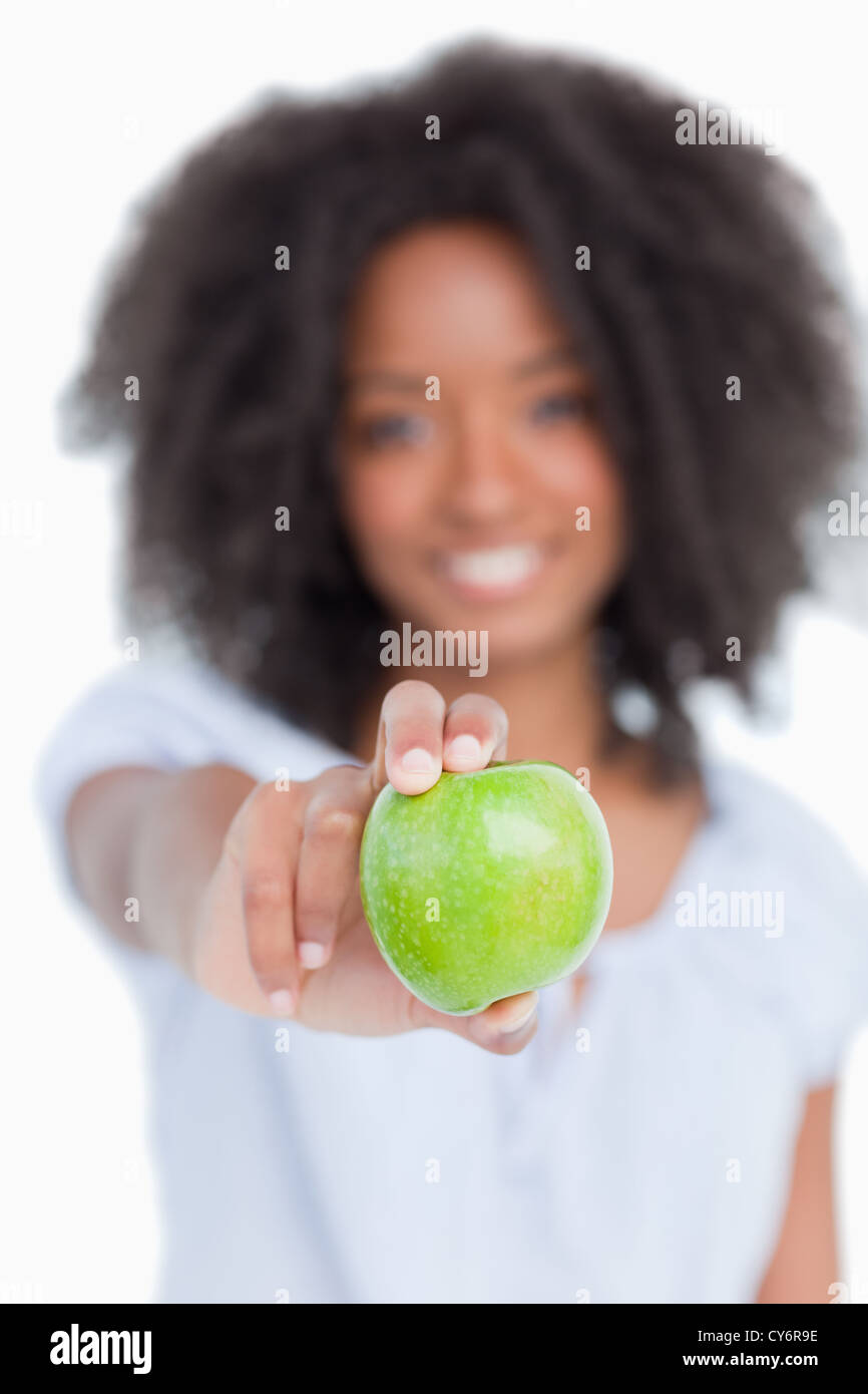 Green apple held by a young woman with curly hair Stock Photo - Alamy