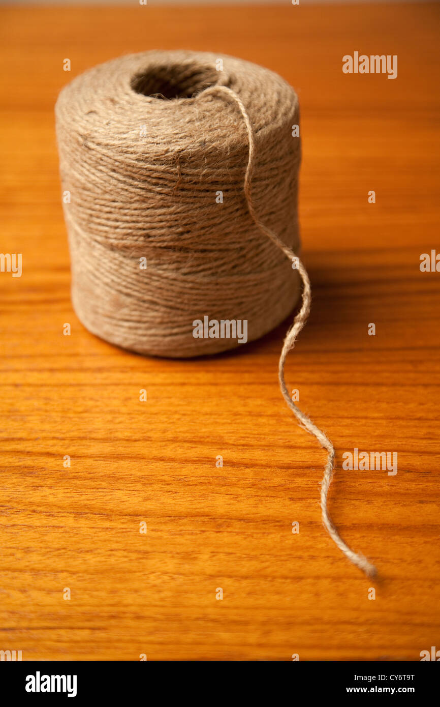 string reel on a wooden table with a extract string, studio shot Stock ...