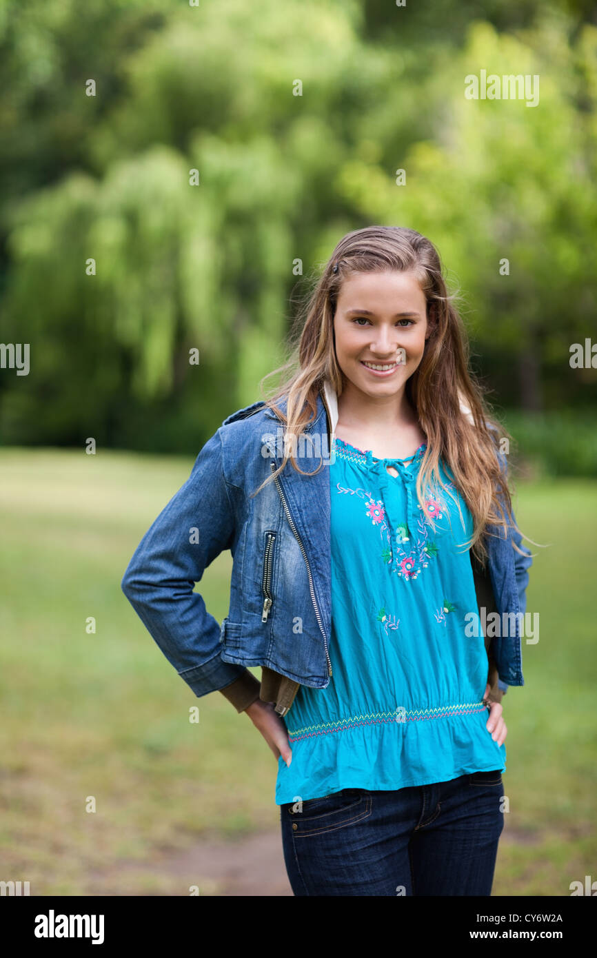 Teenage girl standing upright in the countryside Stock Photo - Alamy