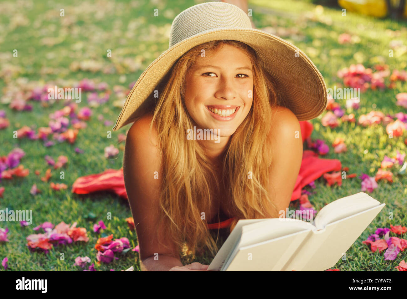 Beautiful Young Woman Reading a Book Outside on the Grass Stock Photo ...