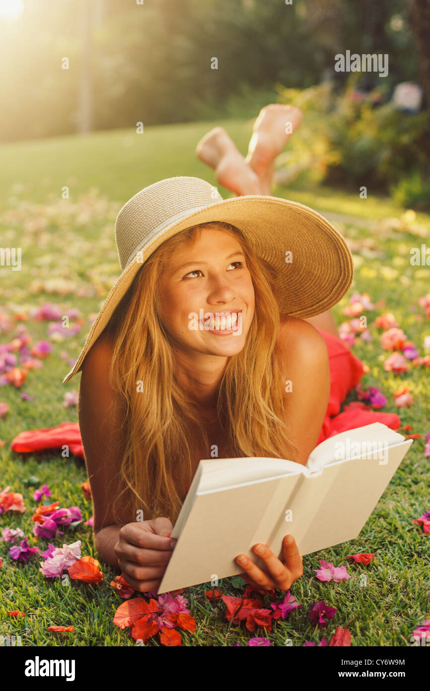Beautiful Young Woman Reading a Book Outside on the Grass Stock Photo ...