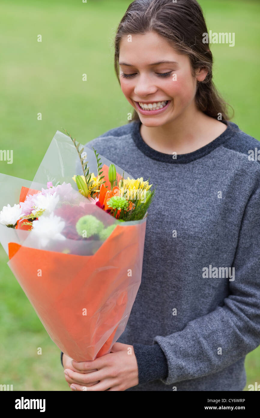 Smiling teenage receiving a bunch of flowers Stock Photo - Alamy