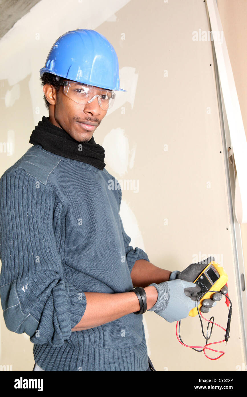 Young electrician with multimeter Stock Photo - Alamy