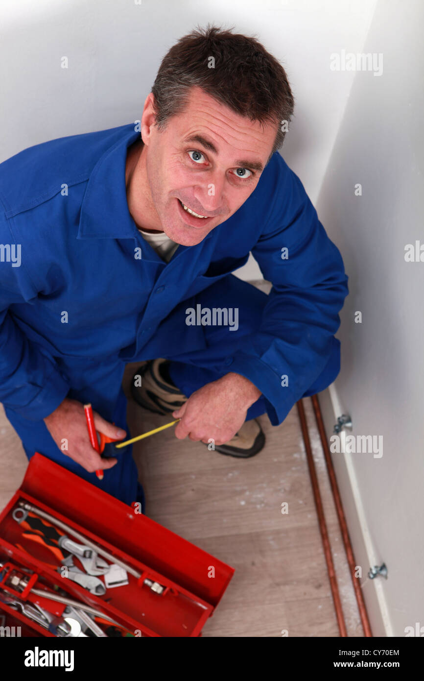 Plumber looking up Stock Photo - Alamy