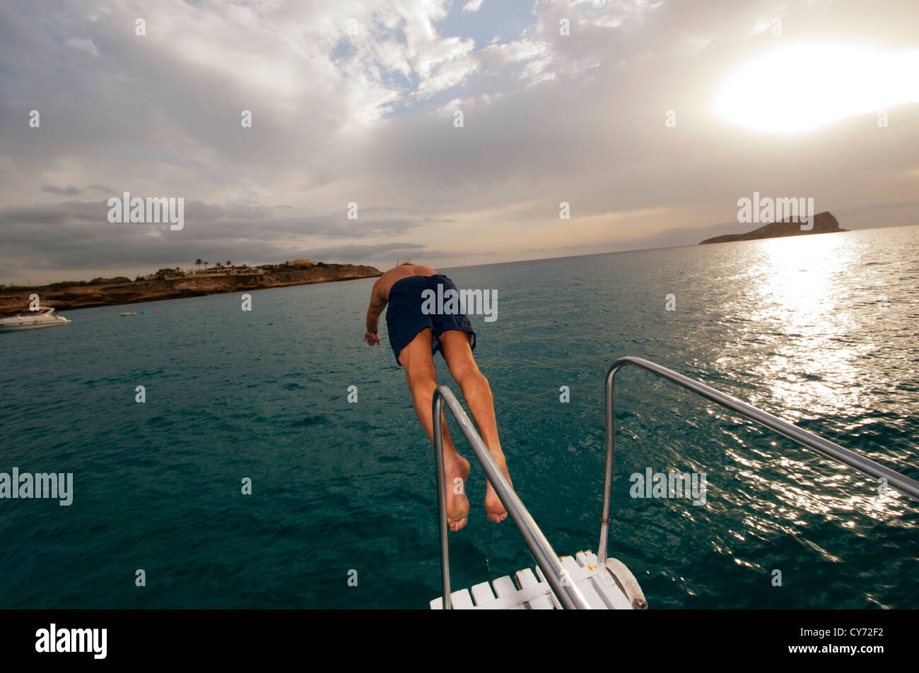 A man jumps into the ocean from a boat in Ibiza, Spain Stock Photo - Alamy