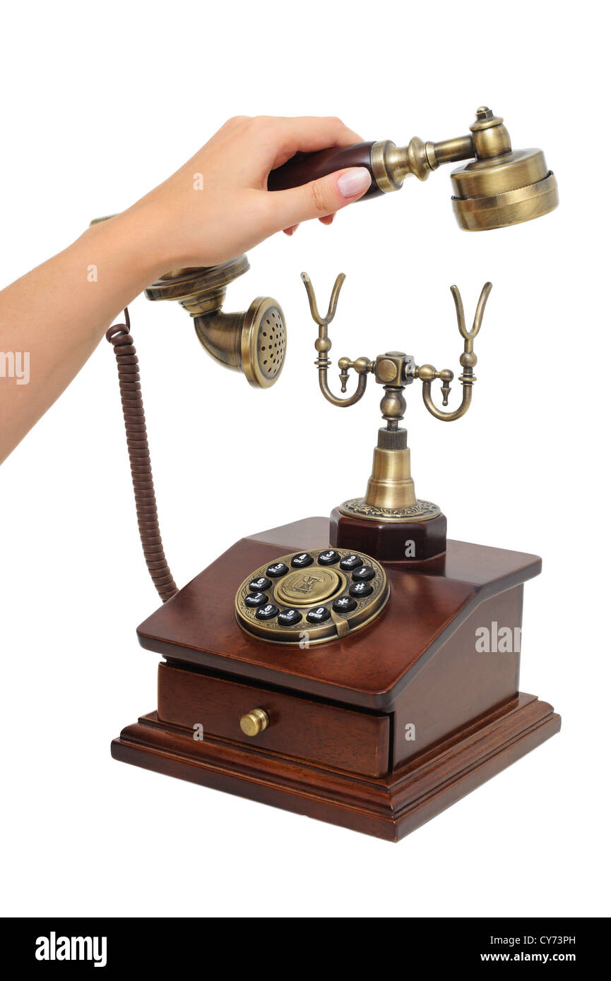 Female hand picking up old-fashioned phone receiver Stock Photo - Alamy