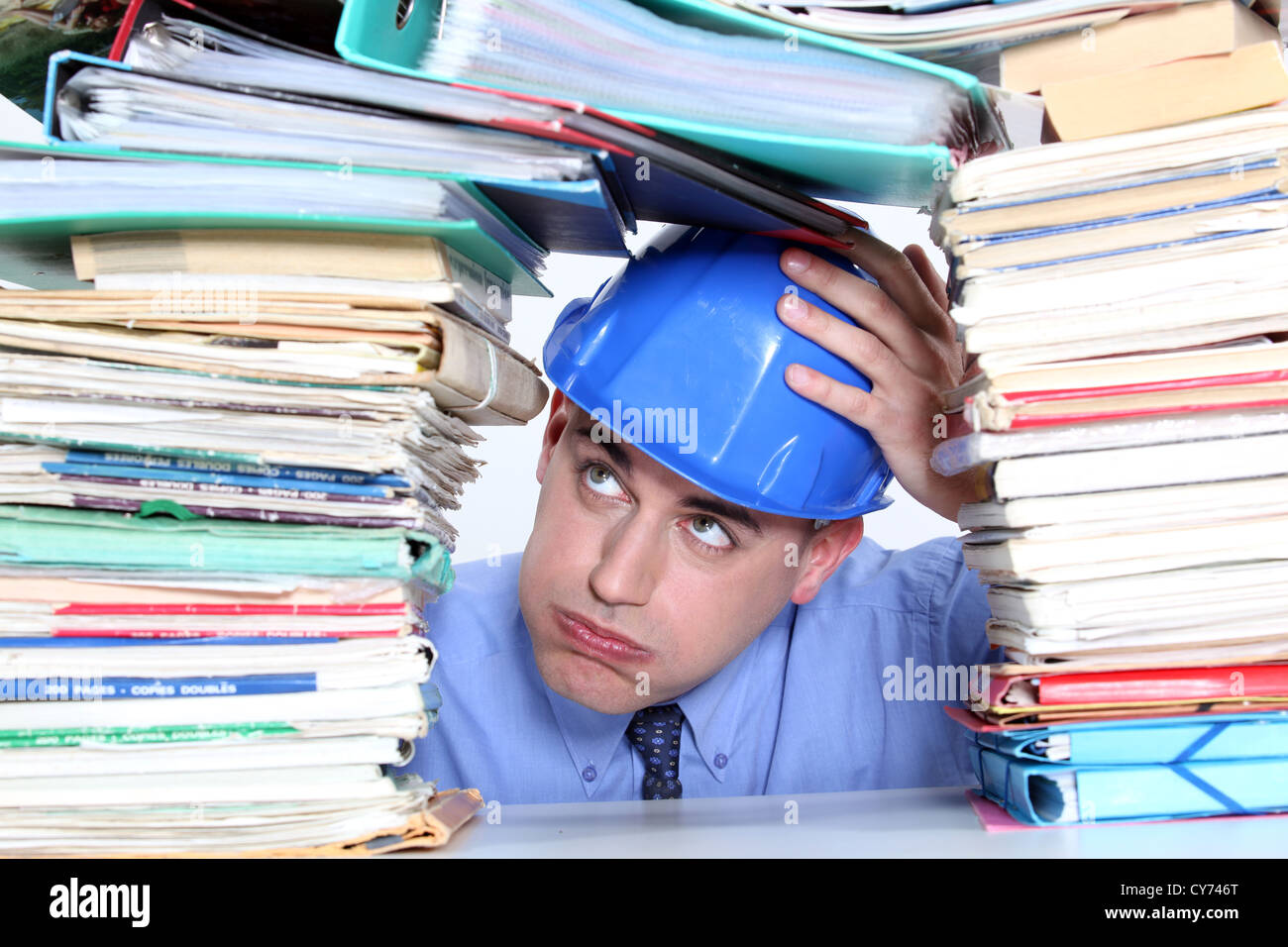 Architect surrounded by piles of paperwork Stock Photo - Alamy