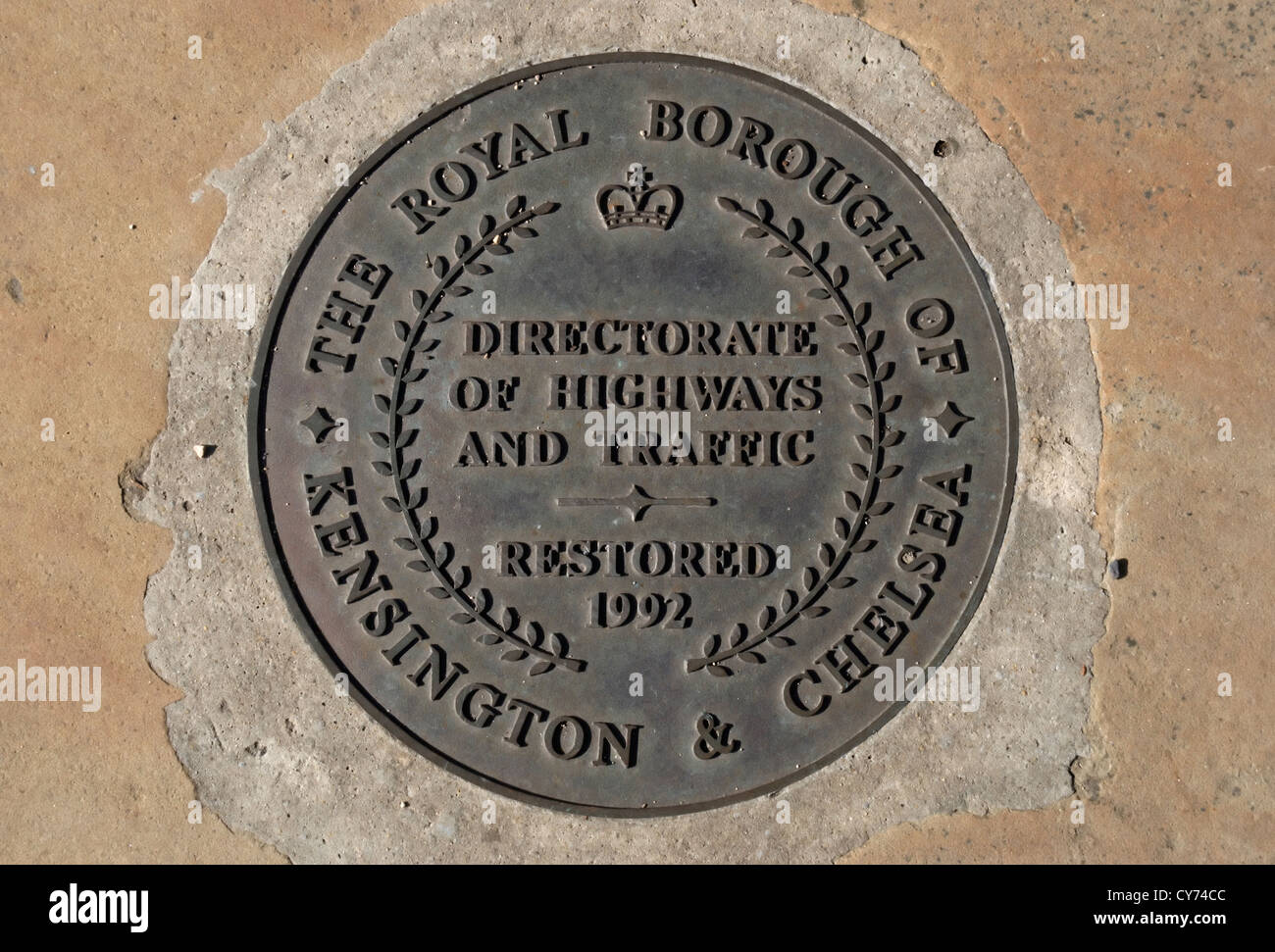 commemorative pavement plaque marking the 1992 restoration of a ...