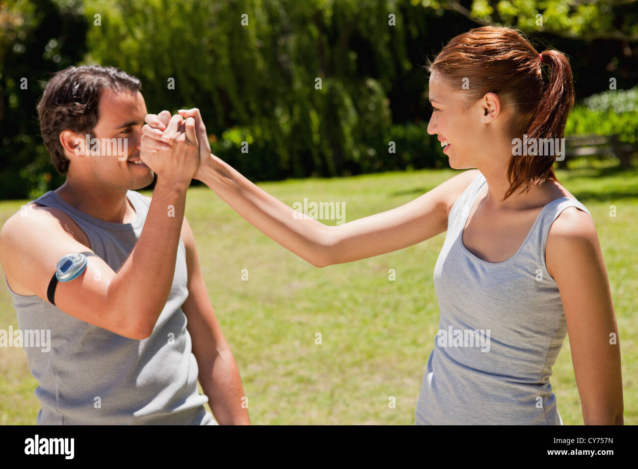 Two friends clasping hands Stock Photo - Alamy