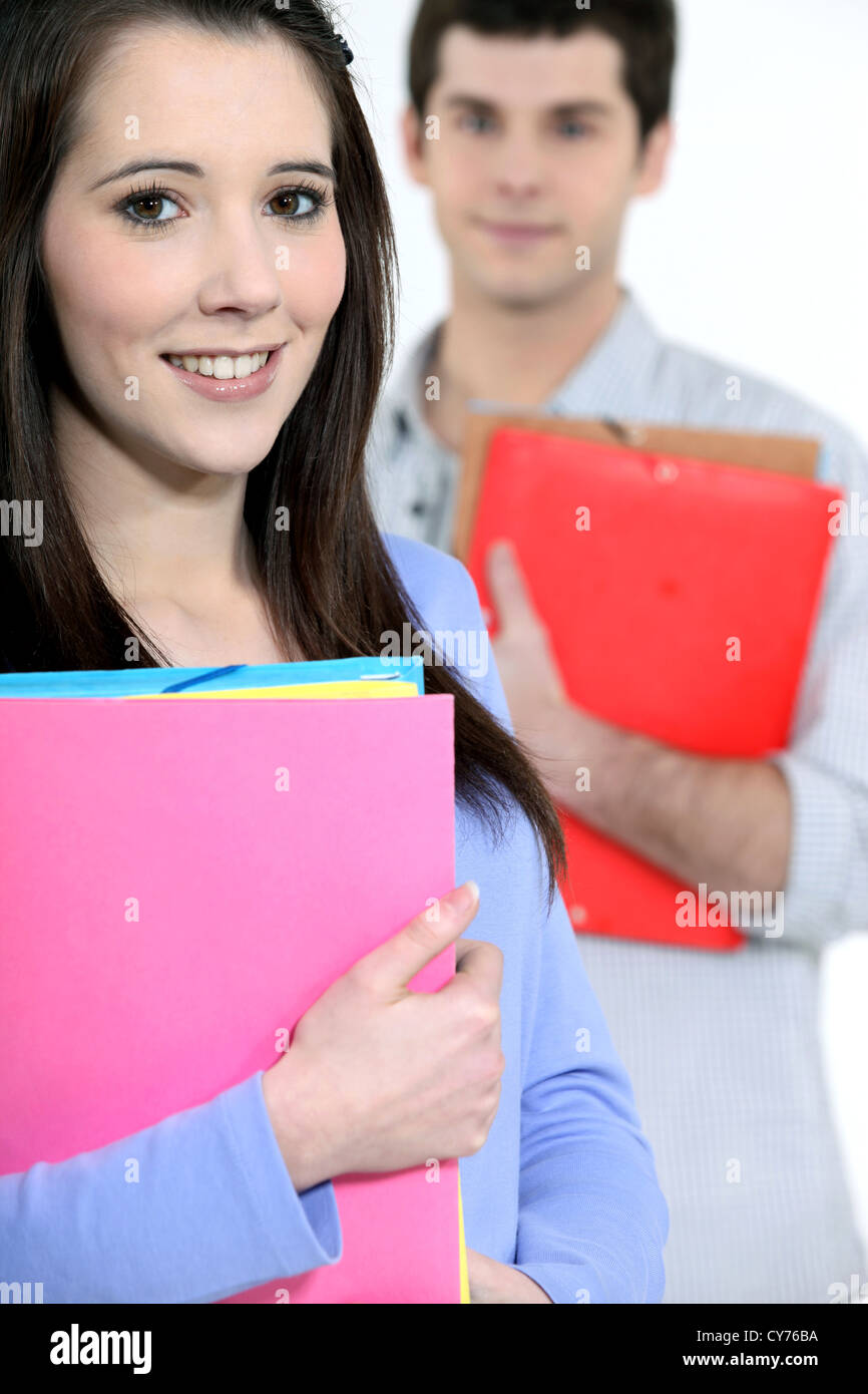 Two students carrying folders Stock Photo - Alamy