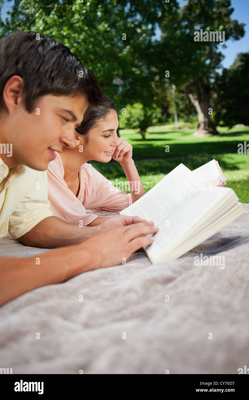 Two friends reading books in a park Stock Photo - Alamy