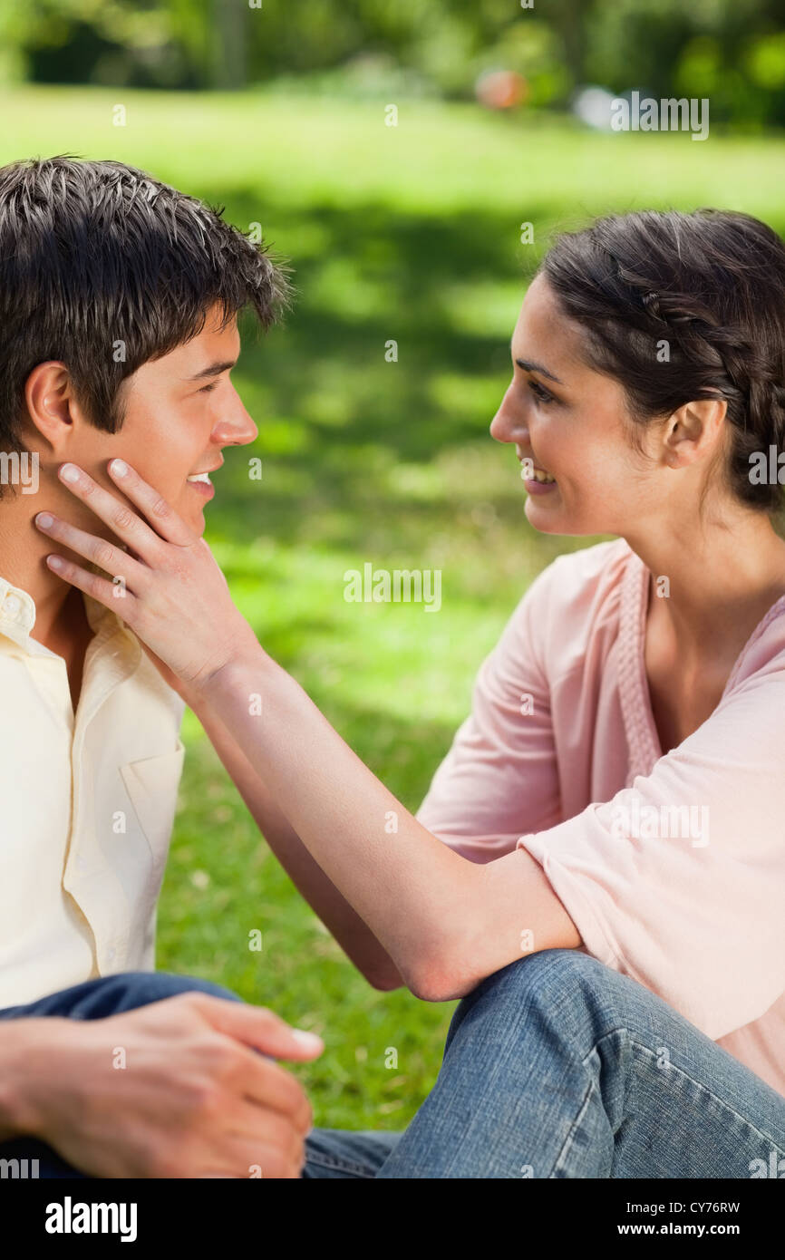 Woman embracing her friends face with her hands Stock Photo - Alamy