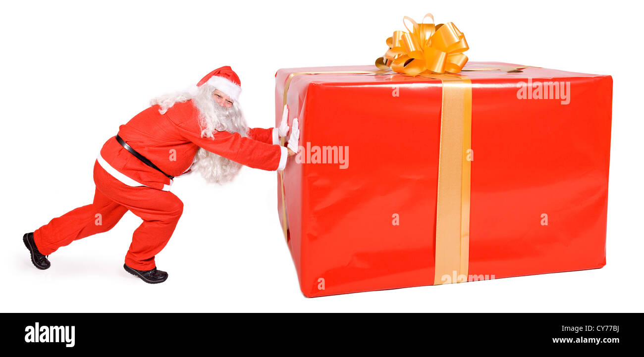 Santa Claus pushing big gift Stock Photo - Alamy