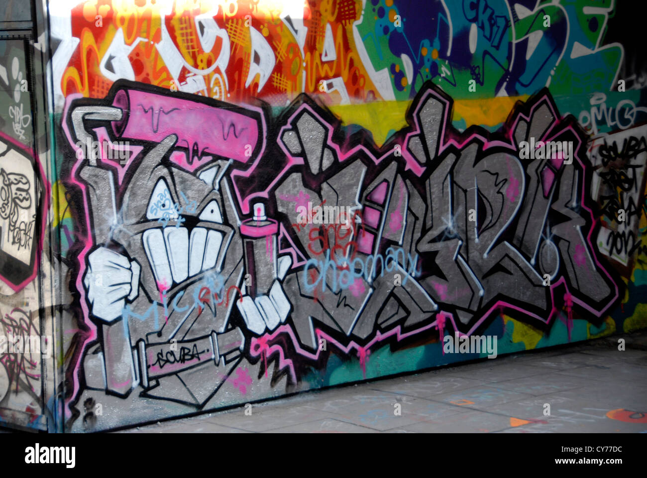 Graffiti on the concrete walls also used for skateboarding beneath the ...