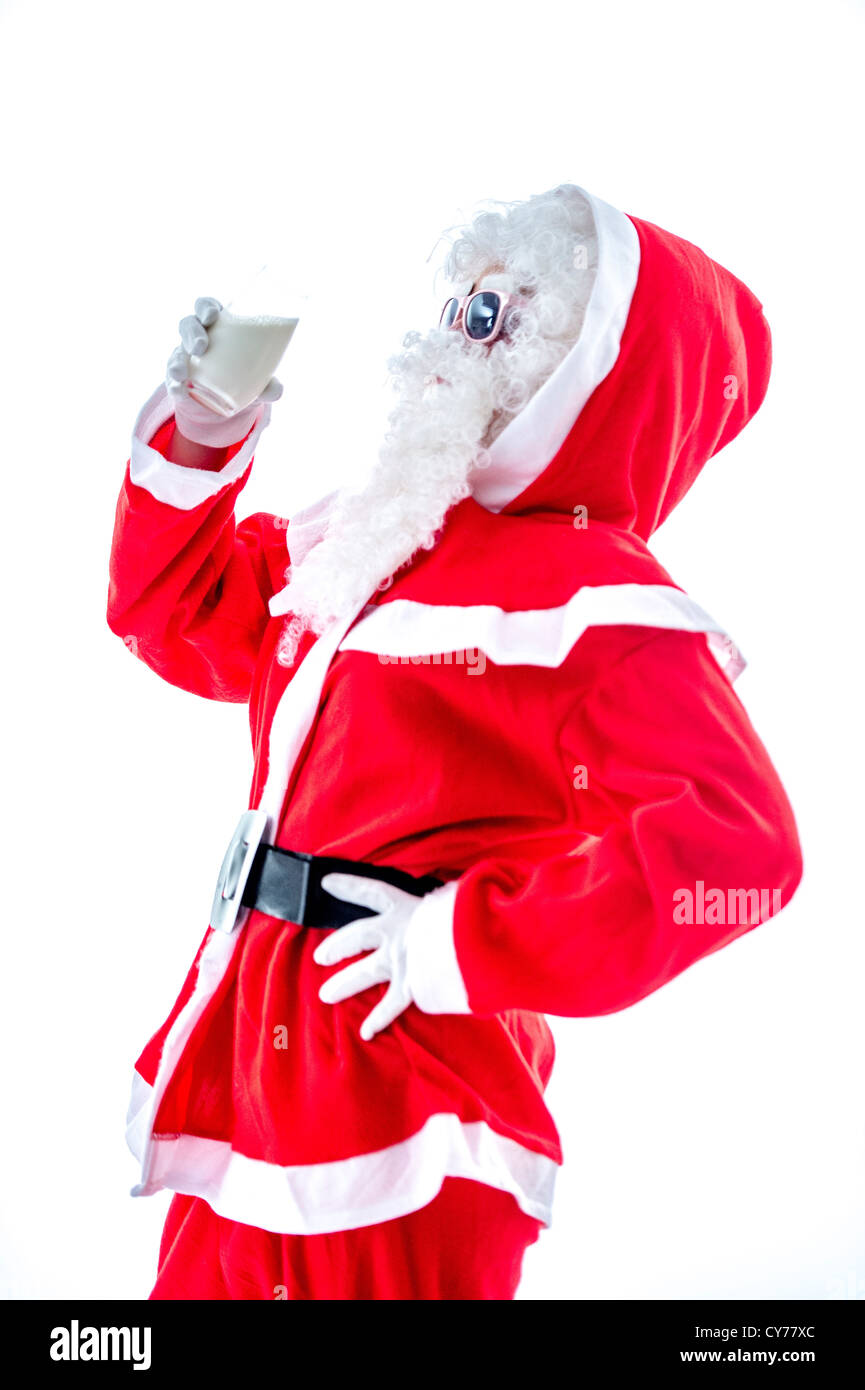 Santa Claus drinking a glass of milk isolated on white background Stock ...