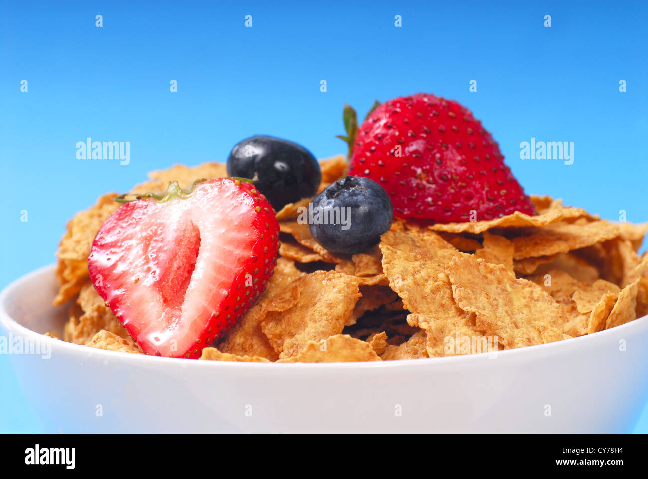 Crispy bran flakes with strawberries and blueberries Stock Photo - Alamy
