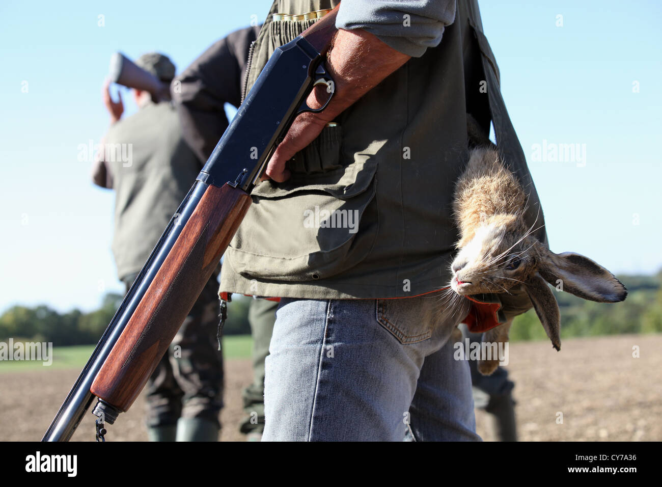 Two hunters out in a field Stock Photo - Alamy