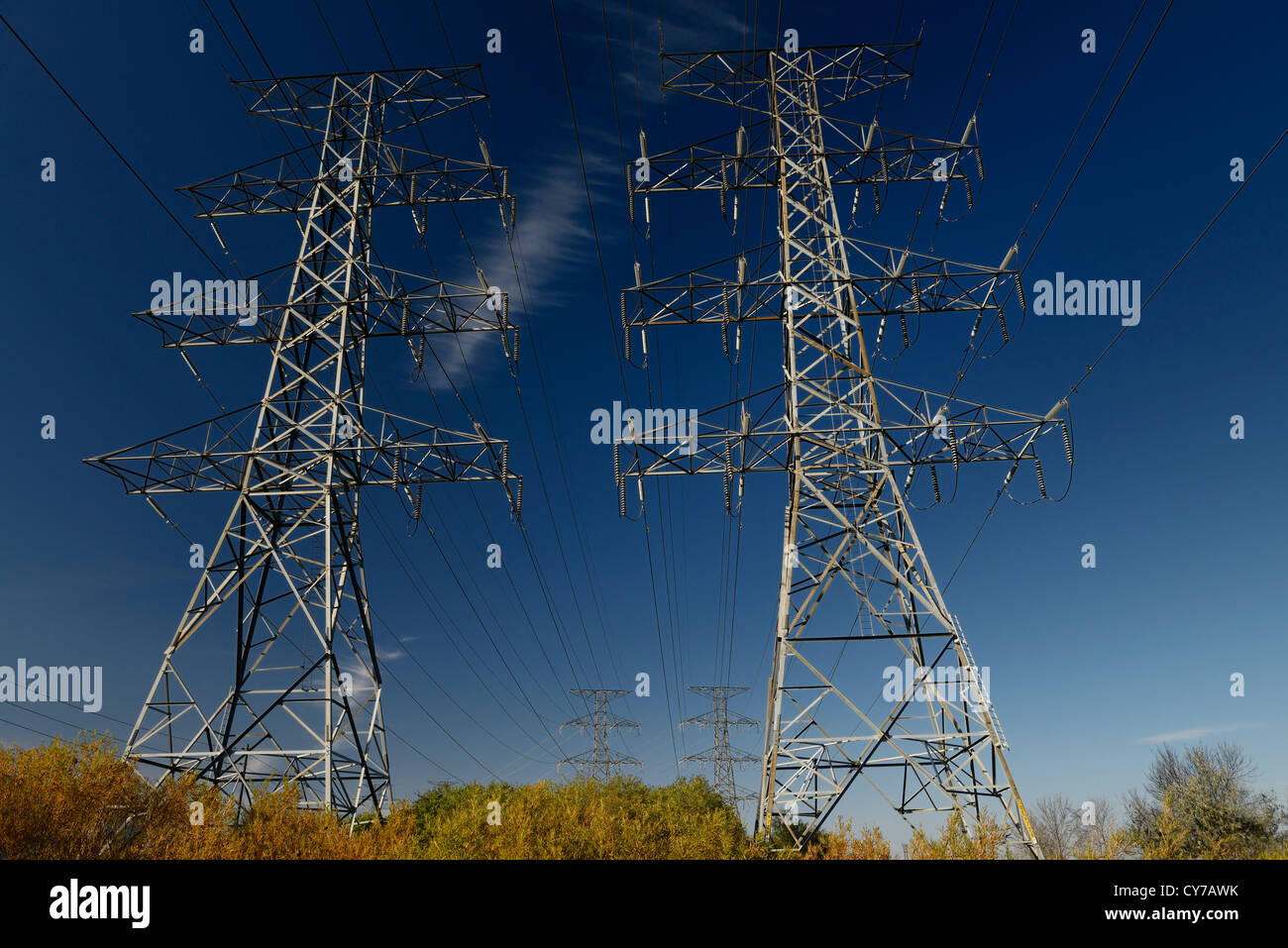 High tension Hydro electric transmission towers against blue sky in the ...