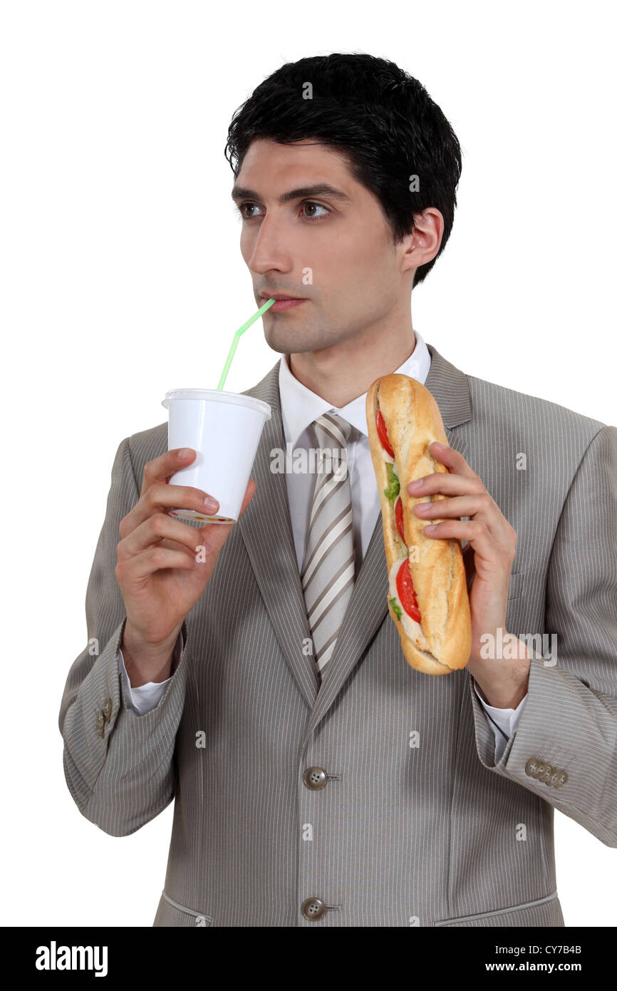 smart pensive businessman having quick lunch break Stock Photo - Alamy