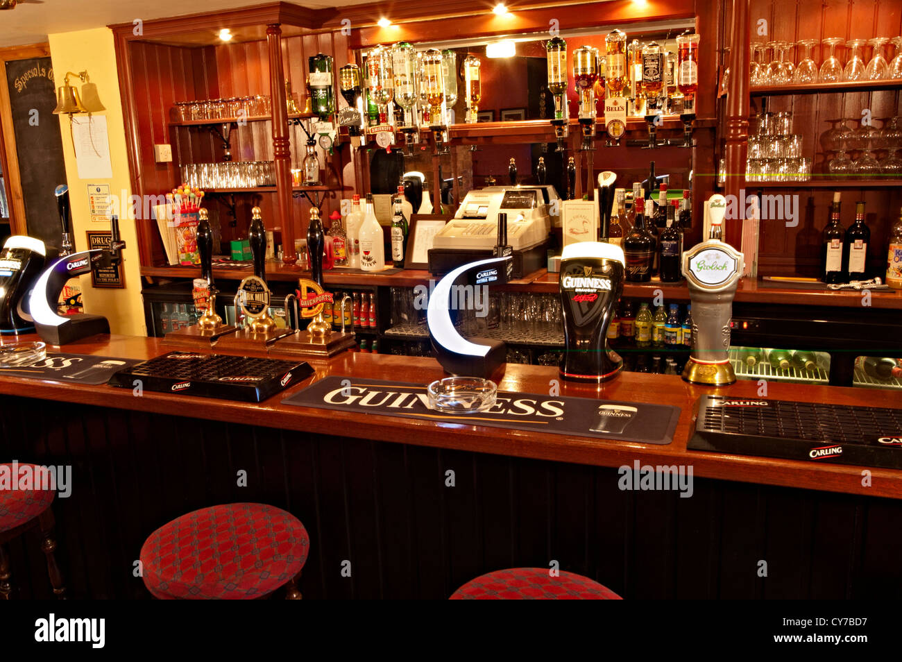 Guinness Beer pump and others at a bar in a pub in the uk Stock Photo ...